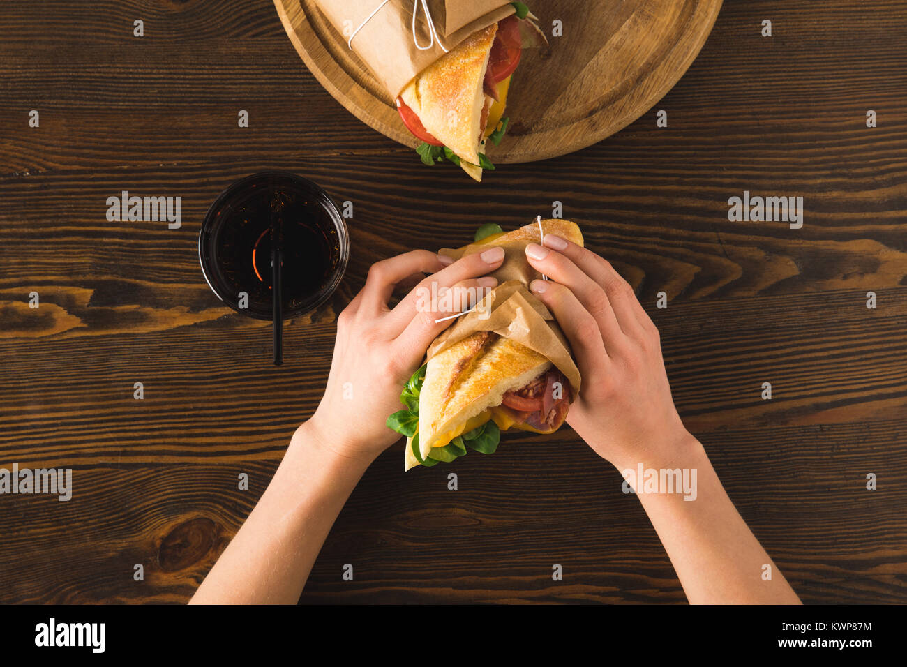 cropped image of woman holding sandwich in hands Stock Photo - Alamy