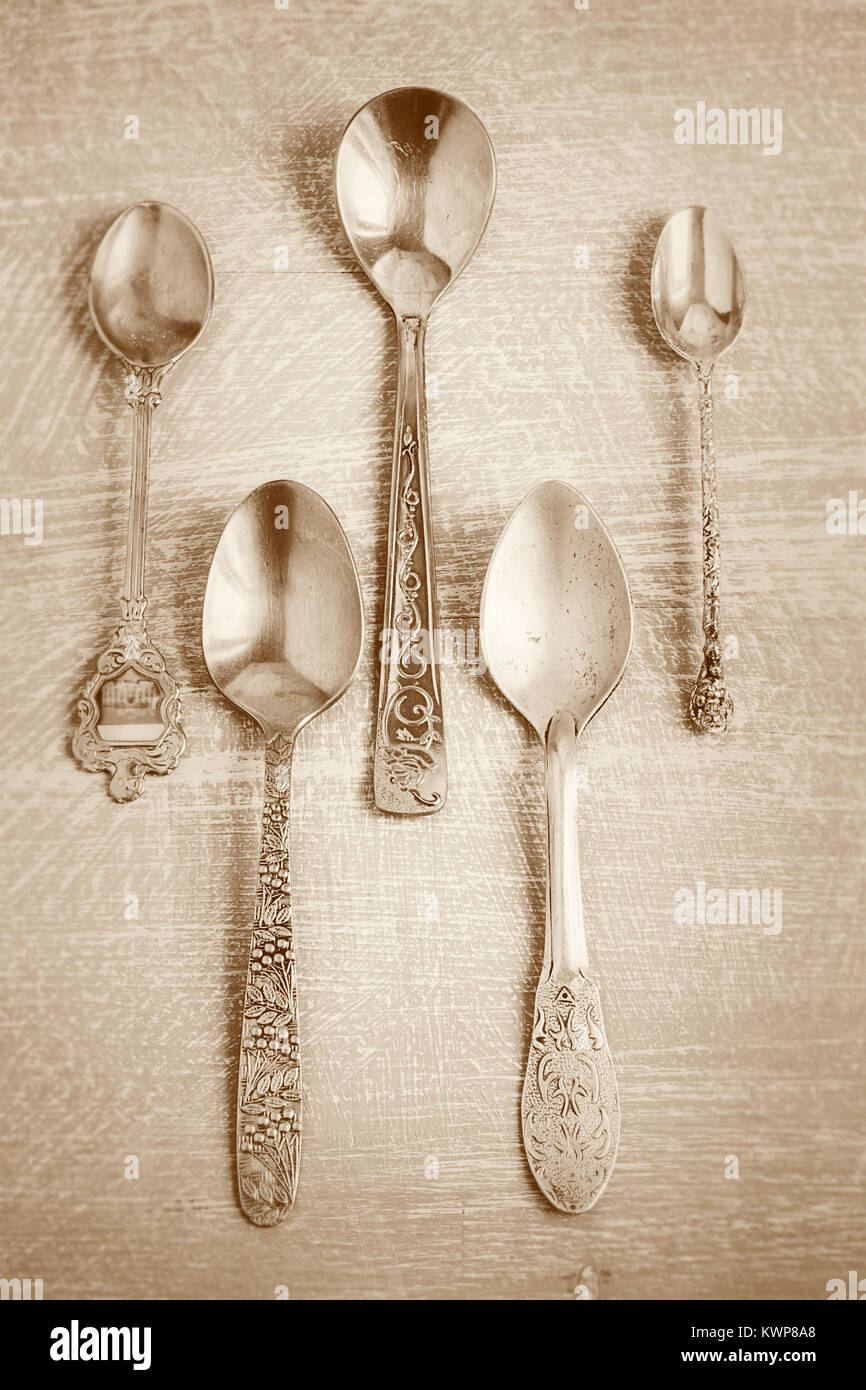 Old teaspoons on vintage background. Monochromatic photo in retro Style ...