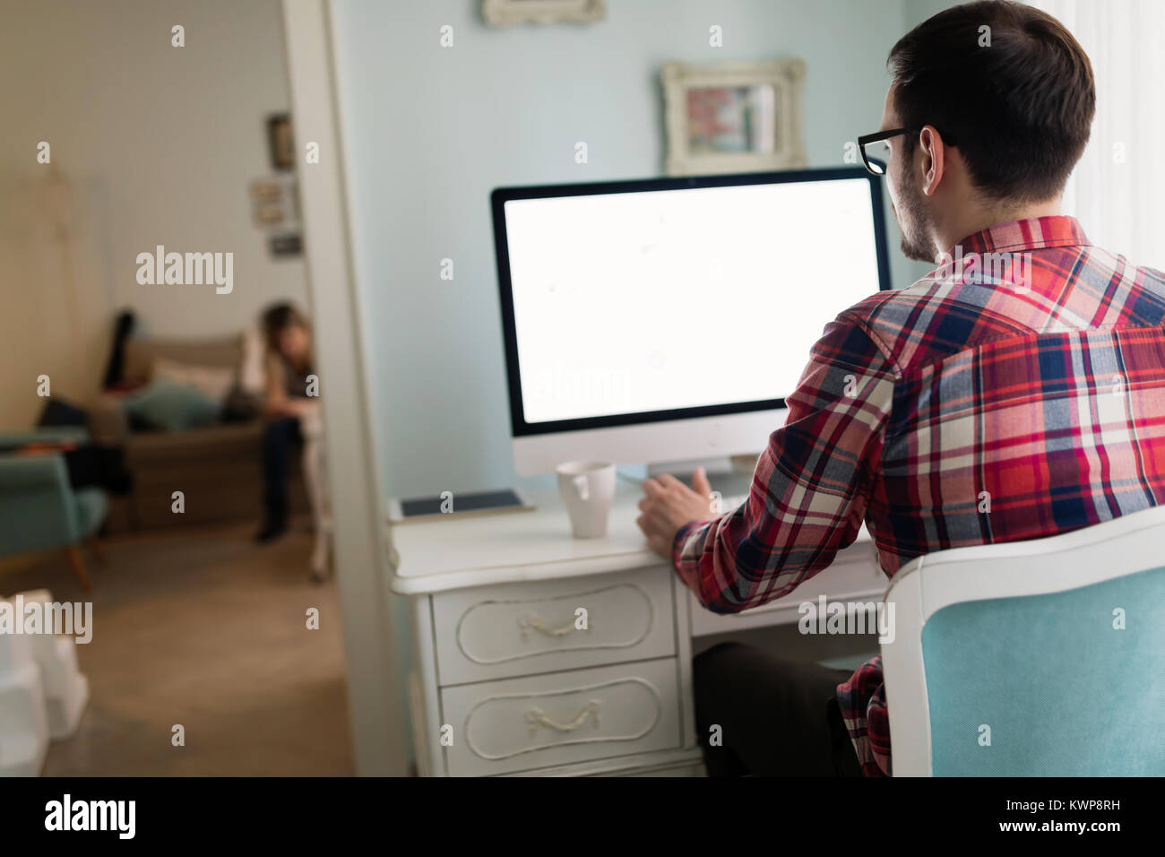 Young handsome designer working on project on computer Stock Photo - Alamy