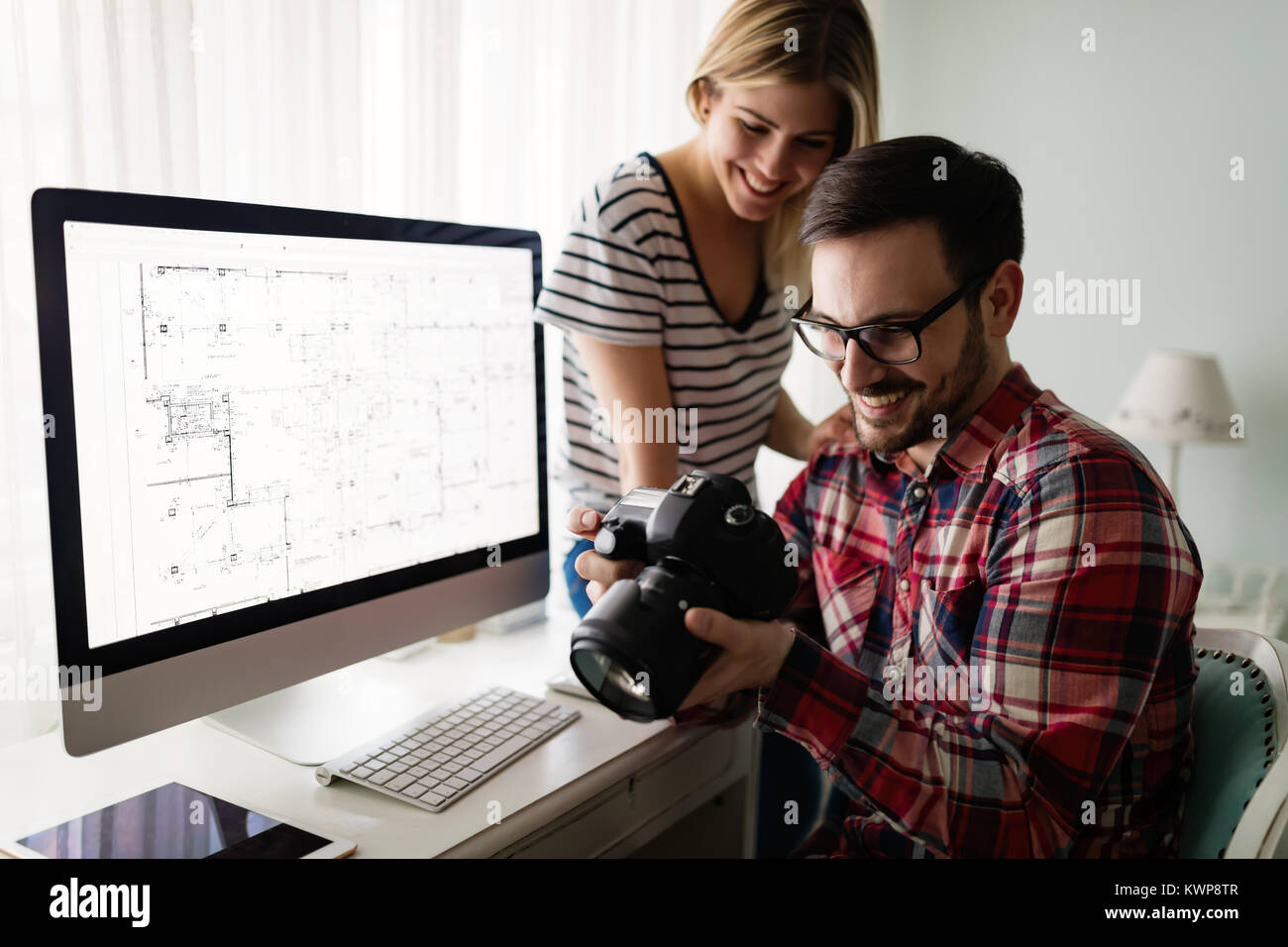 Young attractive designers working together from home Stock Photo - Alamy