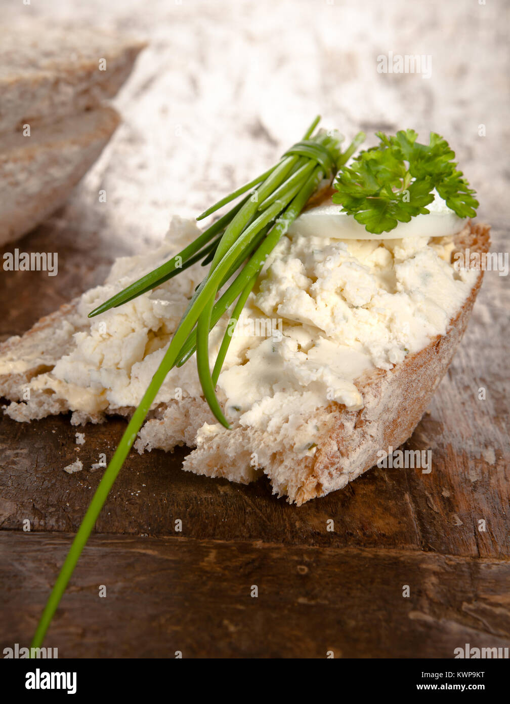 Rustic lunch of buttered bread with cottage cheese and chives Stock ...