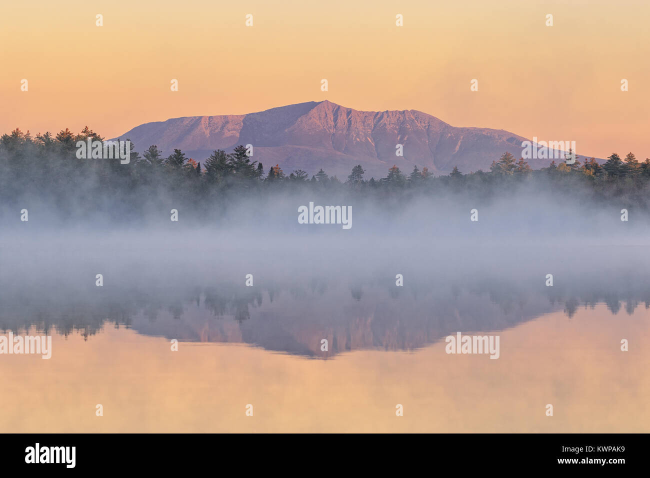 Katahdin and her reflection on a foggy fall morning Stock Photo - Alamy