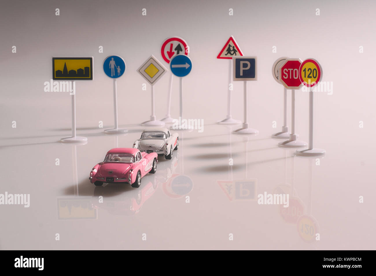 Two retro toy cars in line in front of multiple traffic signs Stock ...