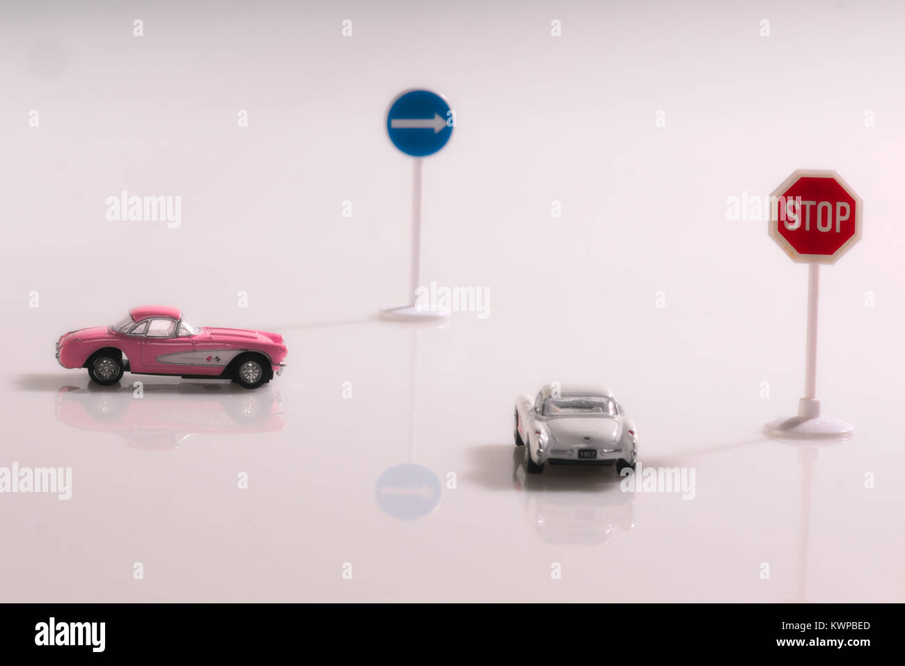 Two retro toy cars in a crossroads under a stop sign Stock Photo - Alamy