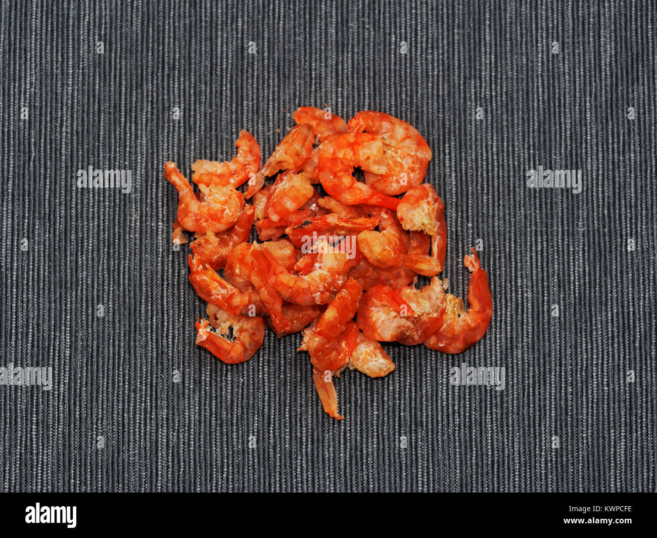 Dried shrimp or prawn isolated on dark linen background used as ...
