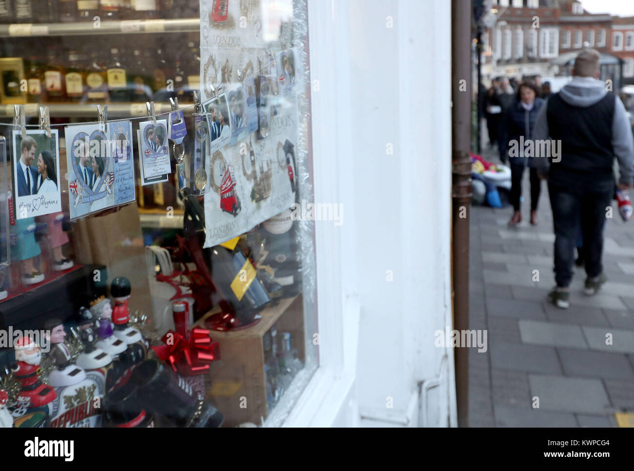 A shop window displays photographs of Prince Harry and Meghan Markle ...