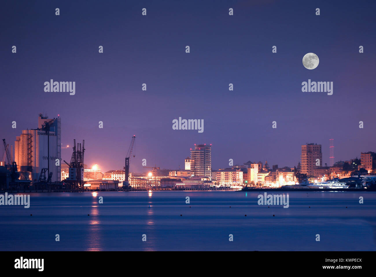 Night view of Savona with sea foreground and Moon in the background ...
