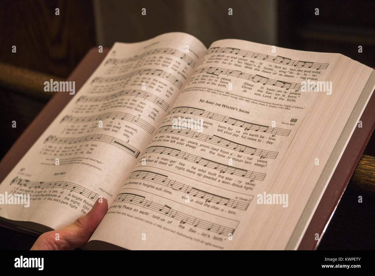 Open church hymnal at Christmas morning Mass at a Catholic church in ...
