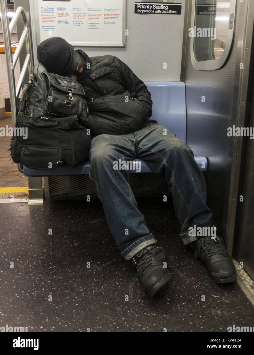 Tired man sleeps on a New York City subway train Stock Photo - Alamy