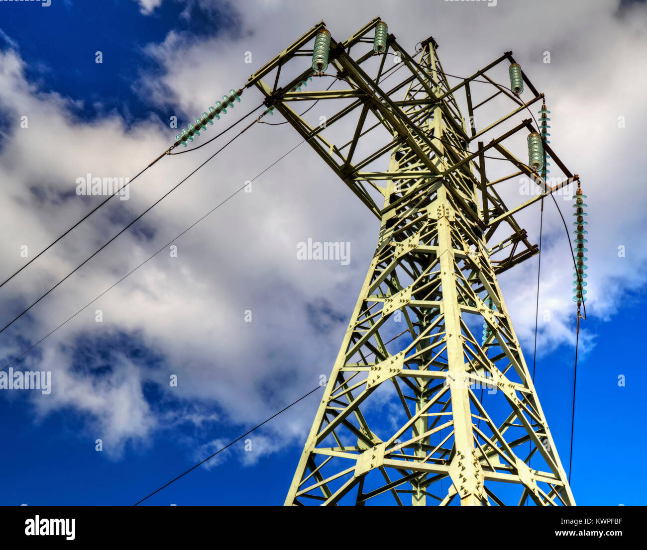 High voltage electrical overhead line on blue sky Stock Photo - Alamy