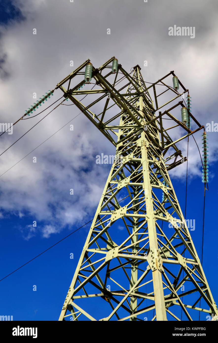 High voltage electrical overhead line on blue sky Stock Photo - Alamy