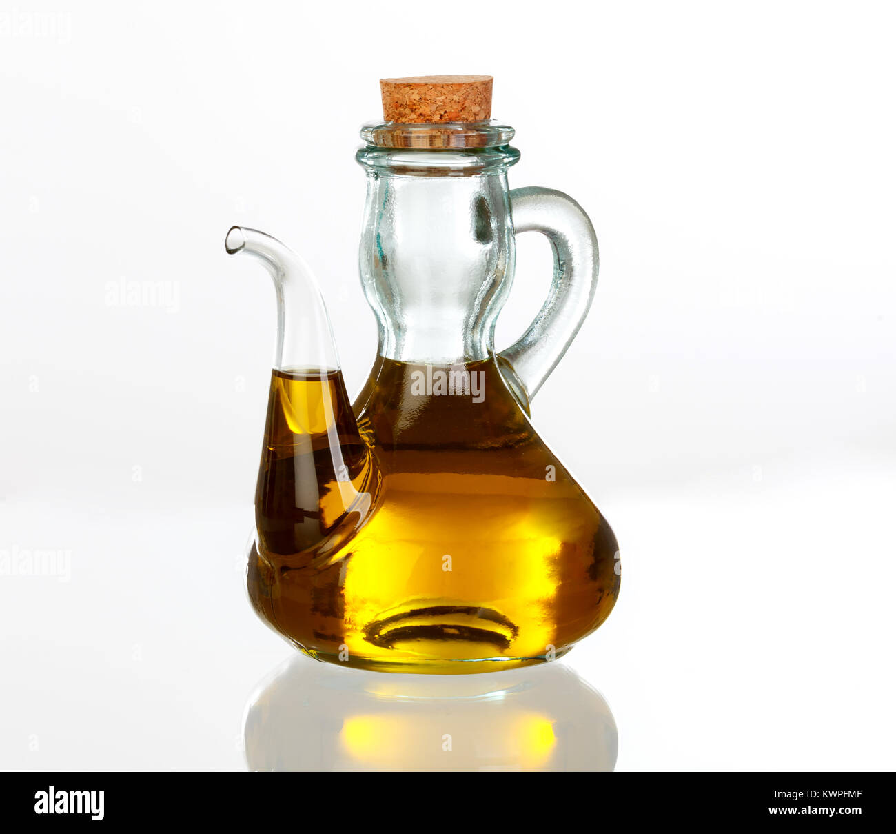 Oil bottle with the golden juice of the olive isolated on white ...