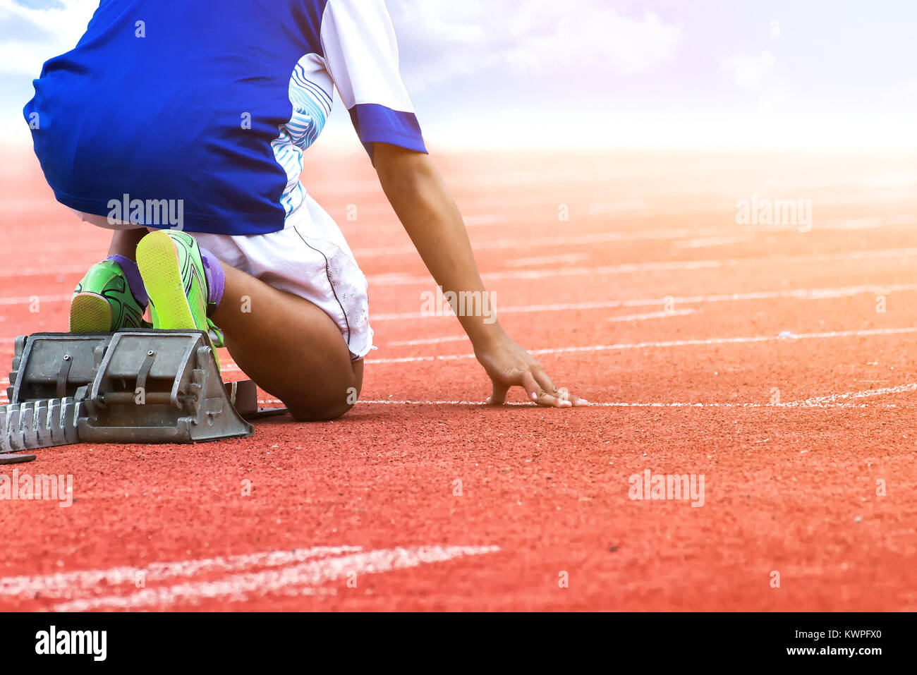 Athlete in the starting block waiting for the start in running track ...