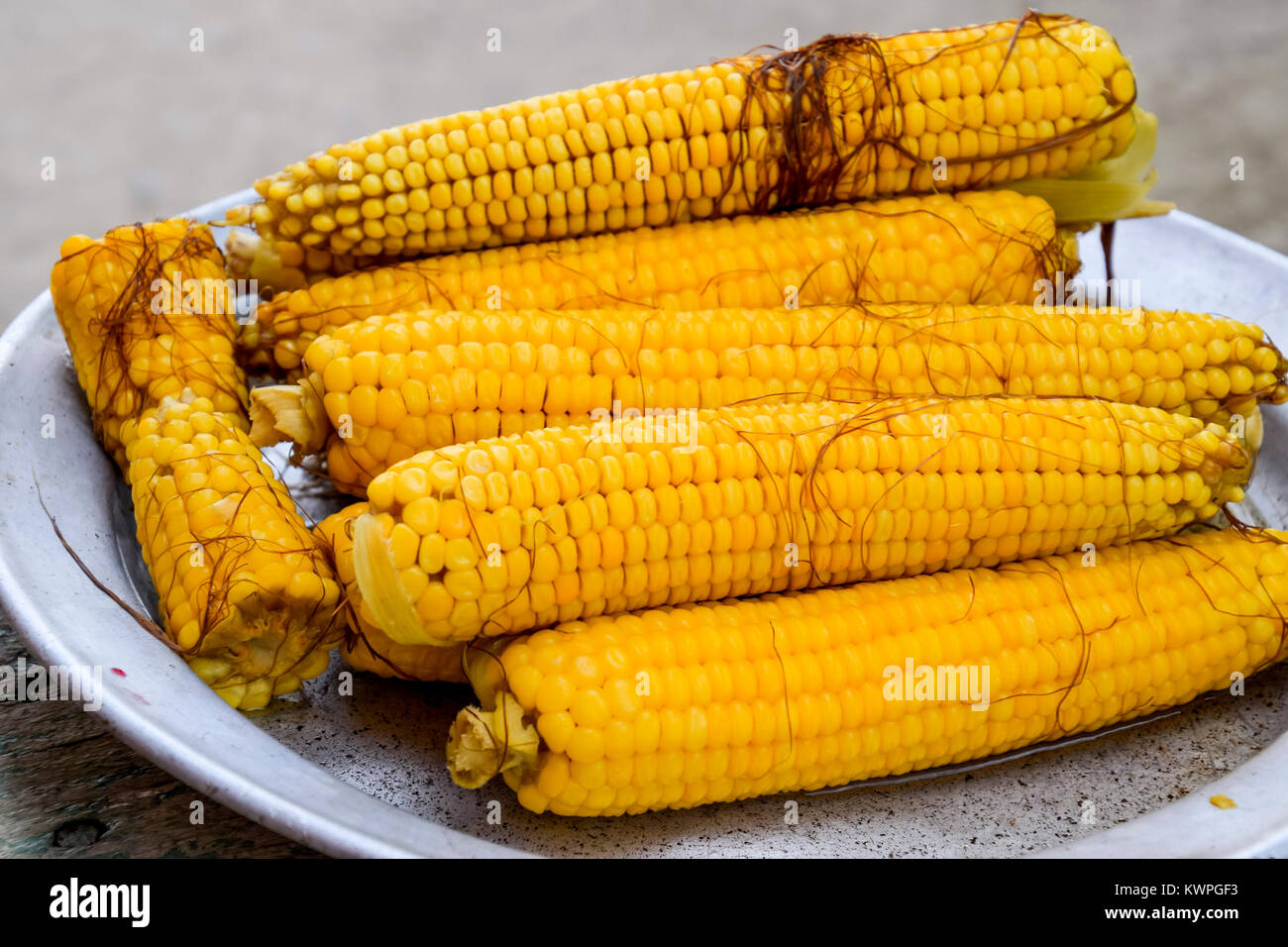 Boiled corn on an aluminum tray. Yellow boiled young corn, useful and ...