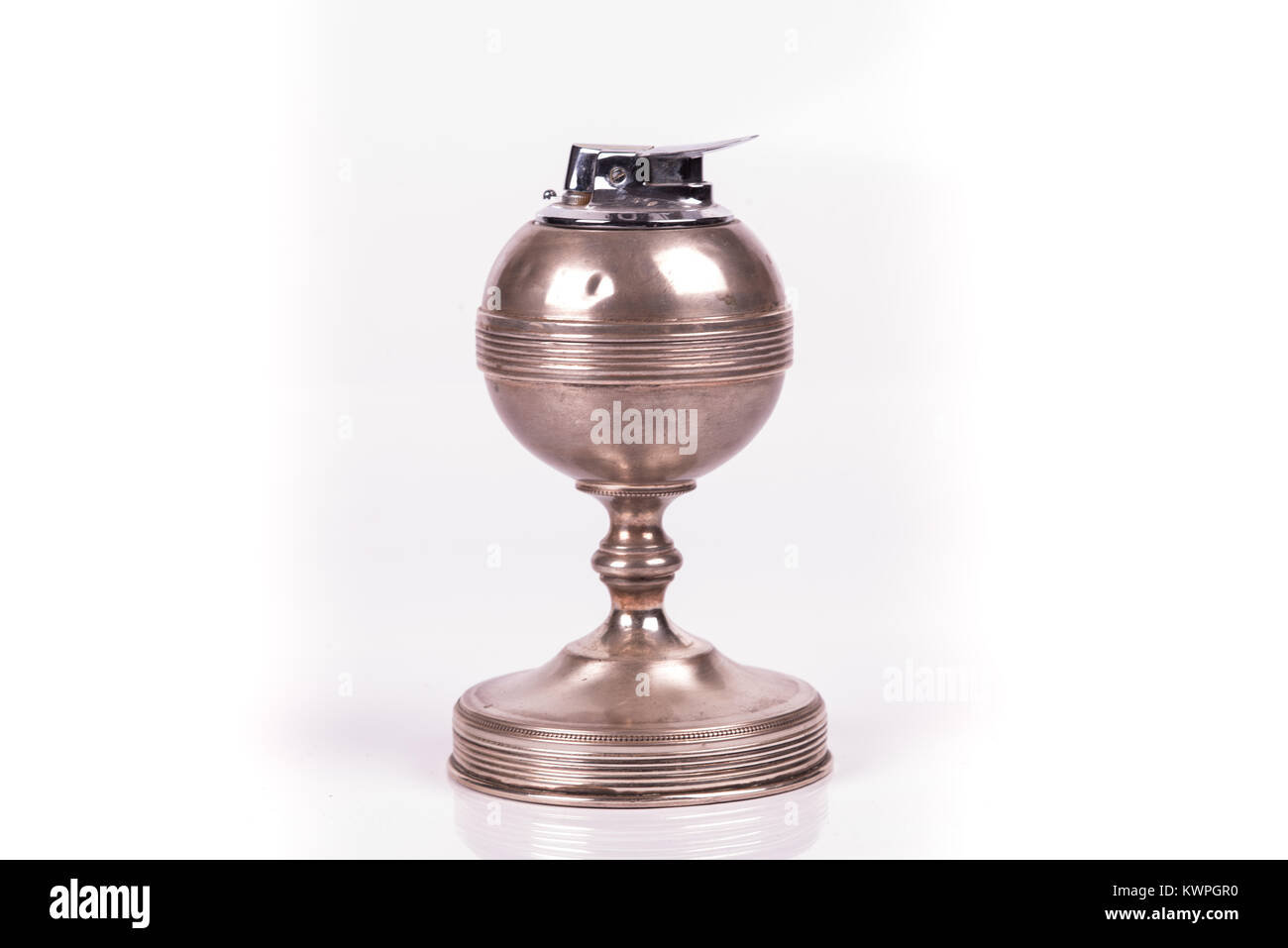 vintage silver lighter from interwar period over a white background ...