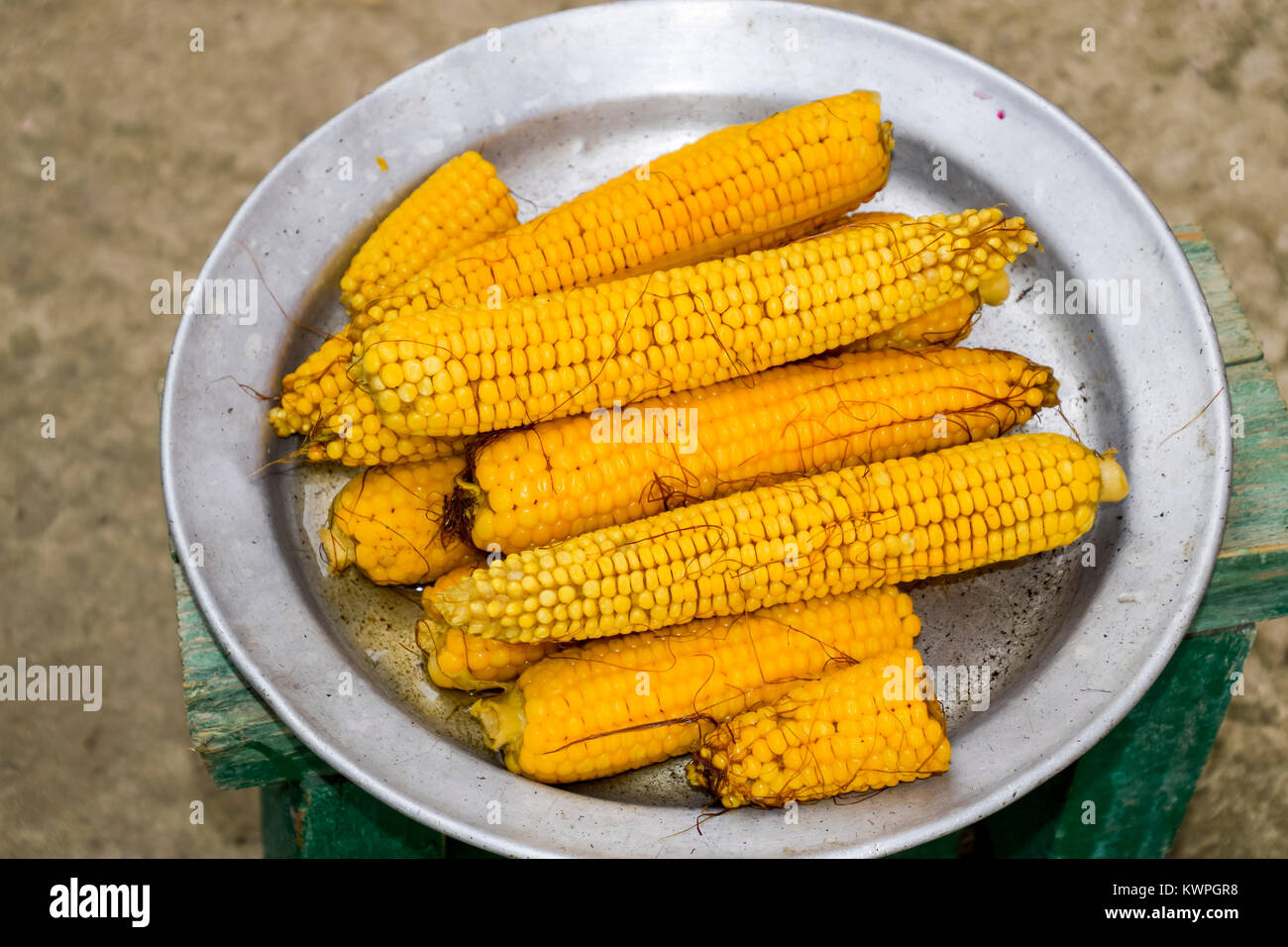 Boiled corn on an aluminum tray. Yellow boiled young corn, useful and ...
