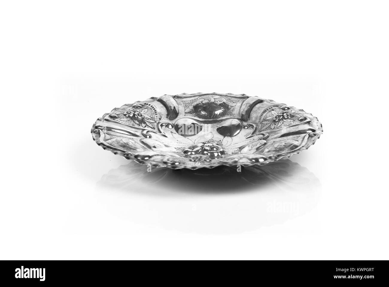 handcrafted antique silver plate decorative over a white background ...