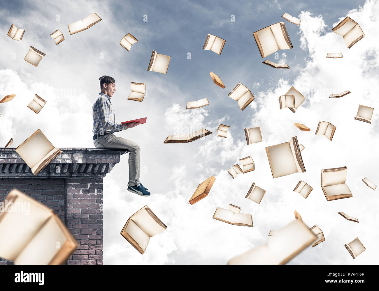 Man reading book and many of them flying in air Stock Photo - Alamy