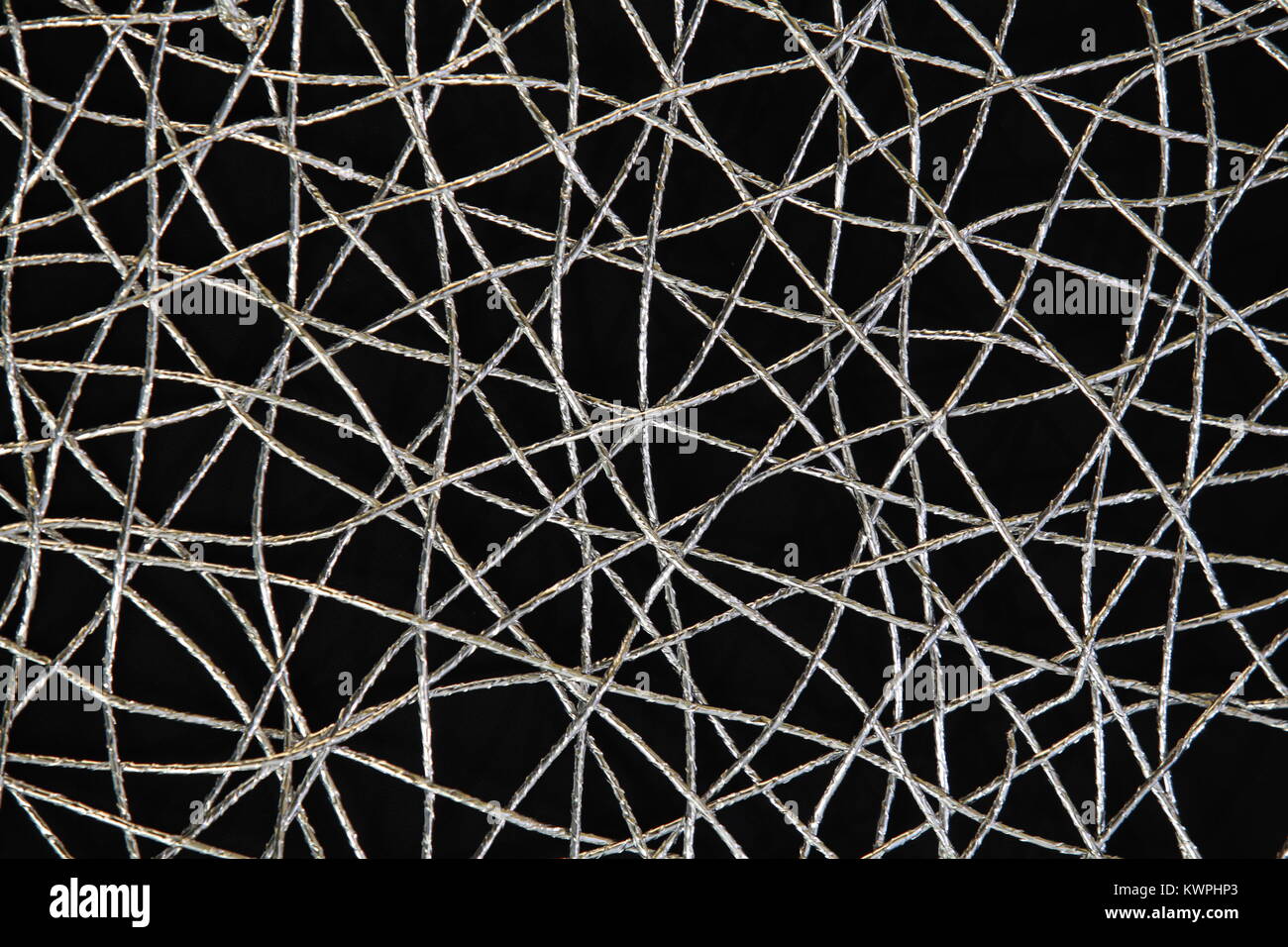 Chaotic weave of silver threads on black, abstract background Stock ...