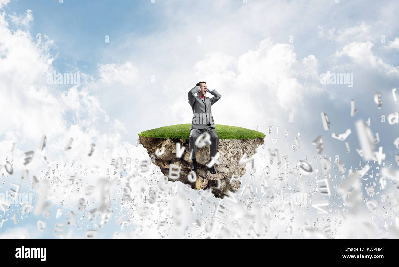 Young man floating in sky and dont want to hear anything Stock Photo ...
