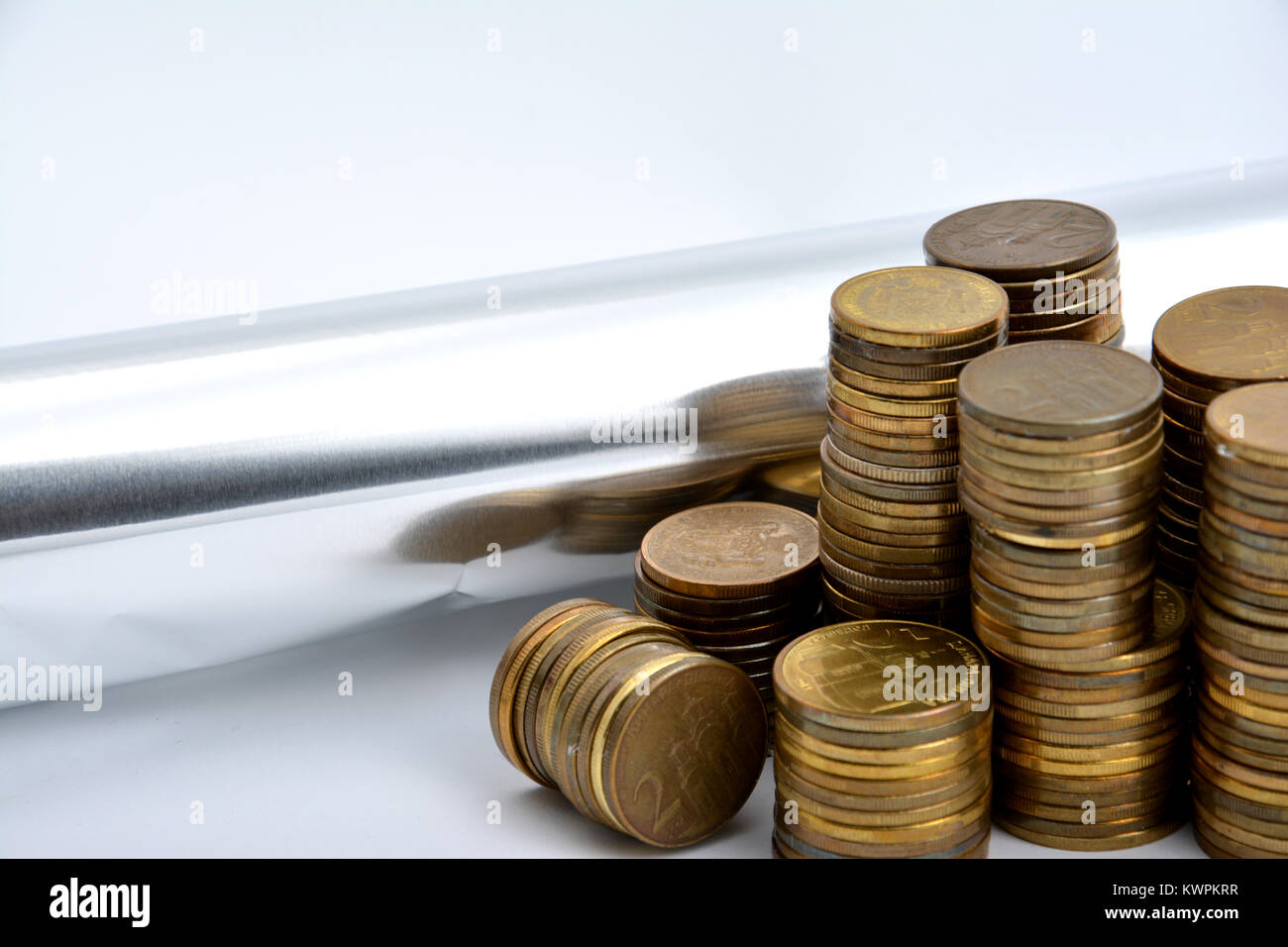 Aluminium foil with coins isolated on white background Stock Photo - Alamy