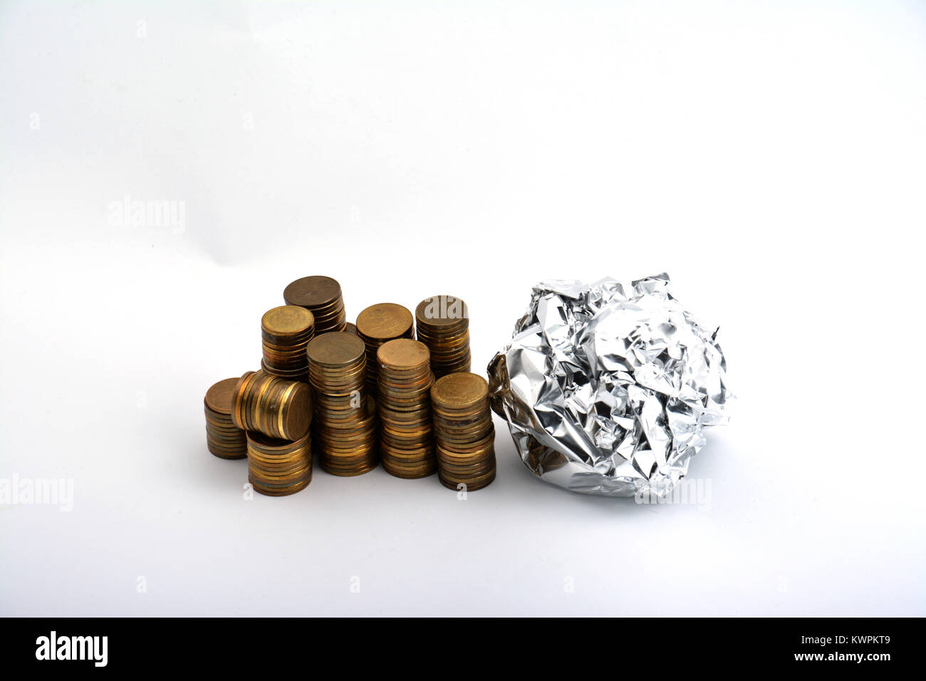 Aluminium foil with coins isolated on white background Stock Photo - Alamy