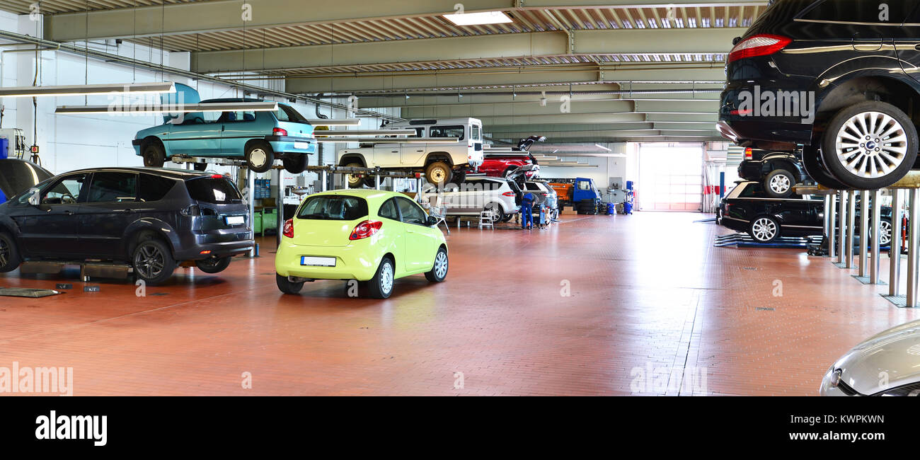 cars on lifting platforms in a workshop for service and repair Stock ...
