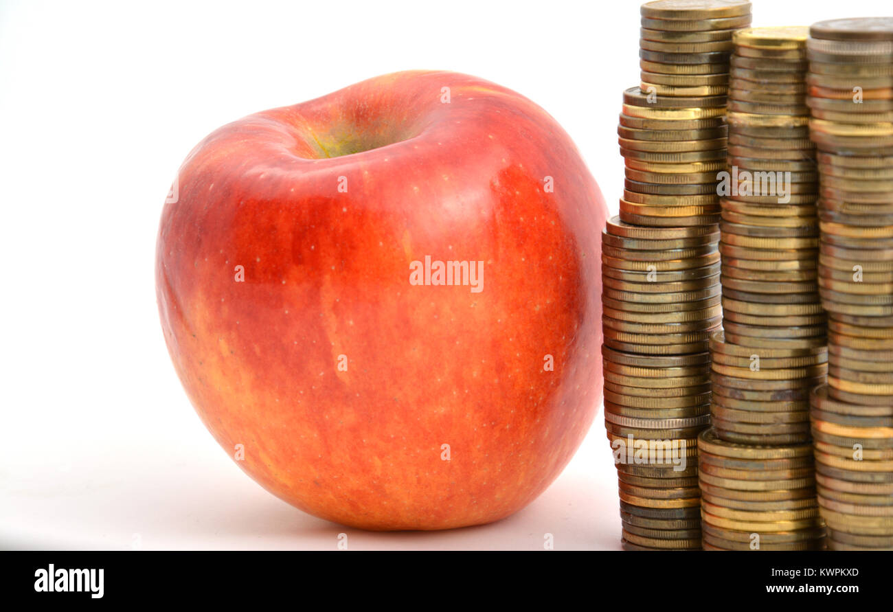 Red apple with coins isolated on white background Stock Photo - Alamy