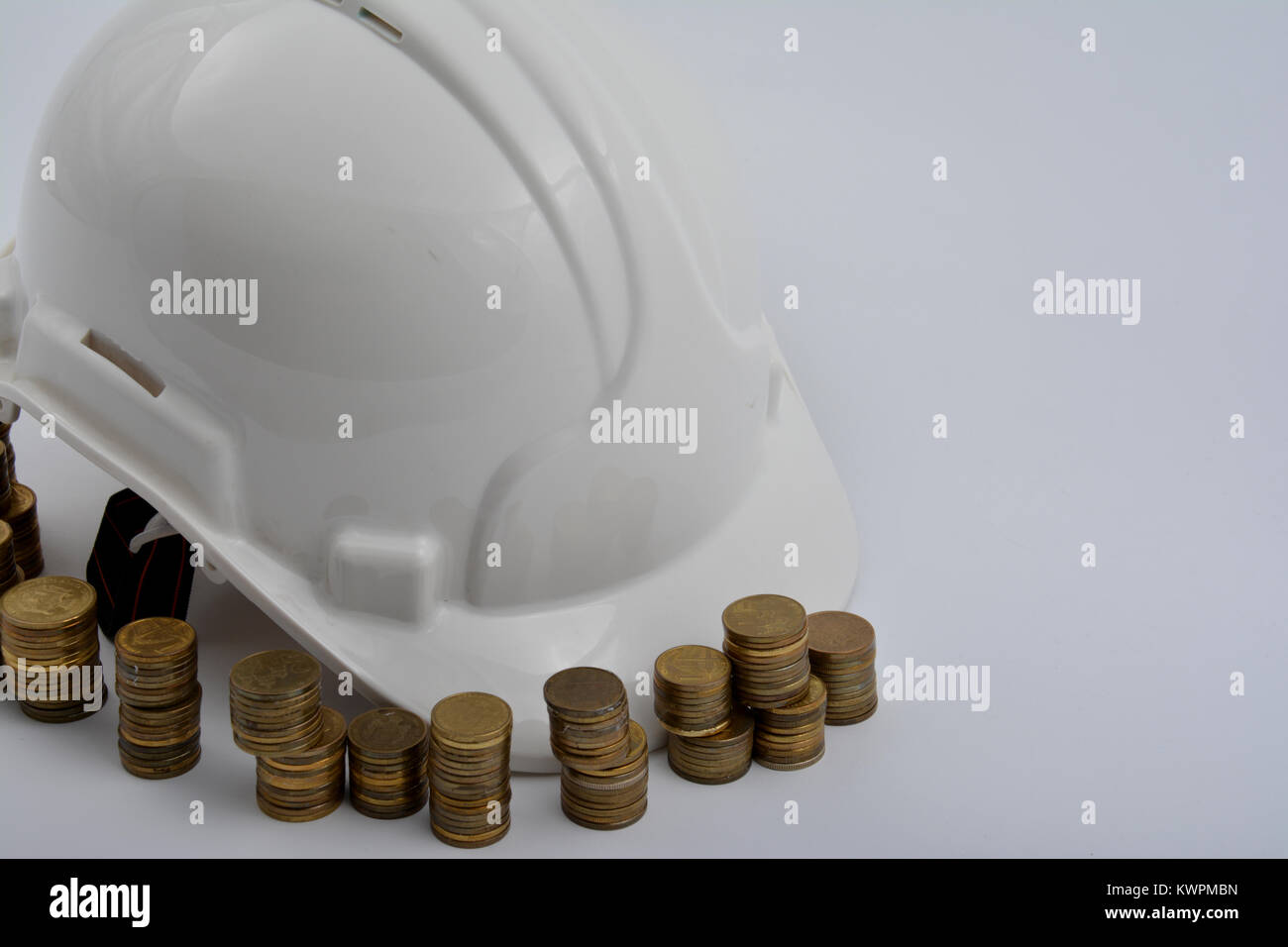 Helmet with coins isolated on white background Stock Photo - Alamy