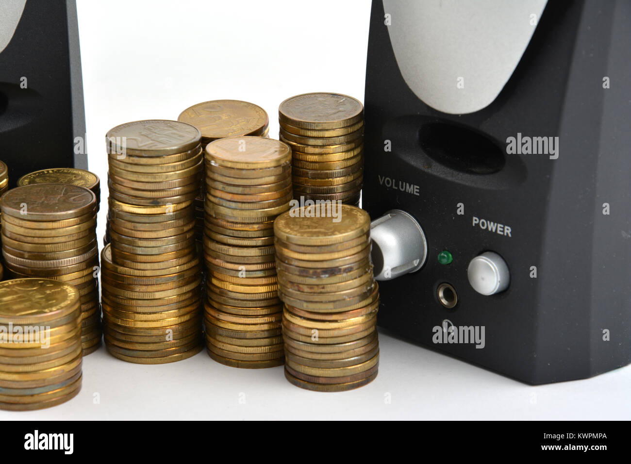 Speakers with coins isolated on white background Stock Photo - Alamy