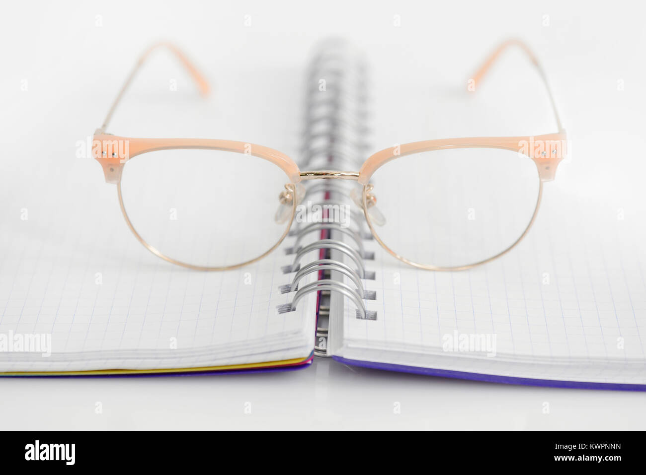 Eye glasses with opened blank spiral notebook on white background Stock ...