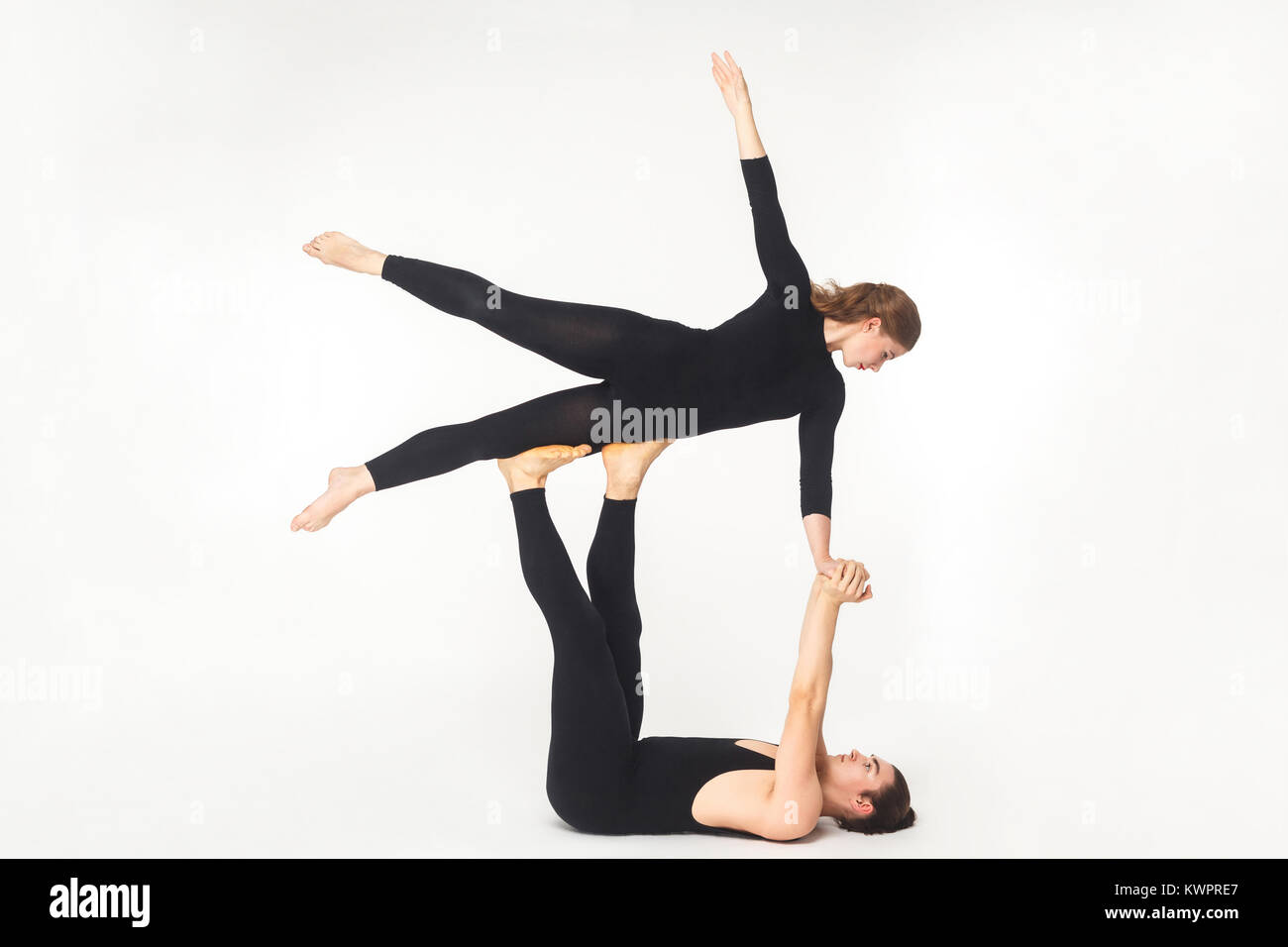 Acroyoga concept, fly pose. Young man holding woman and balancing ...
