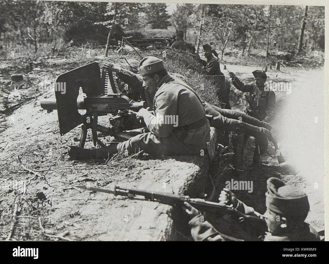 A historical image showing a machine gun positioned on a fortified ...