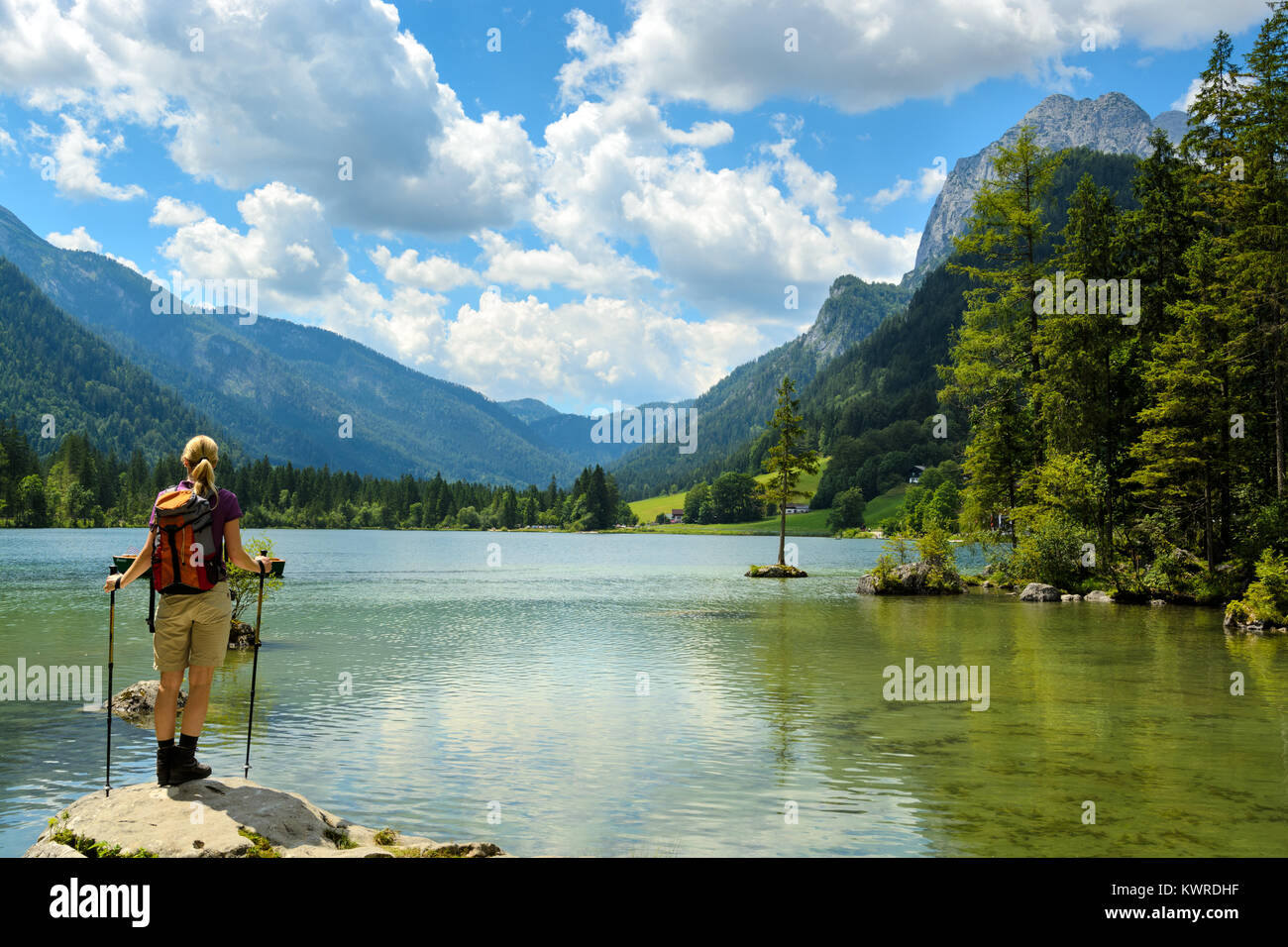 Hiker woman stands overlooking Hintersee lake Stock Photo - Alamy