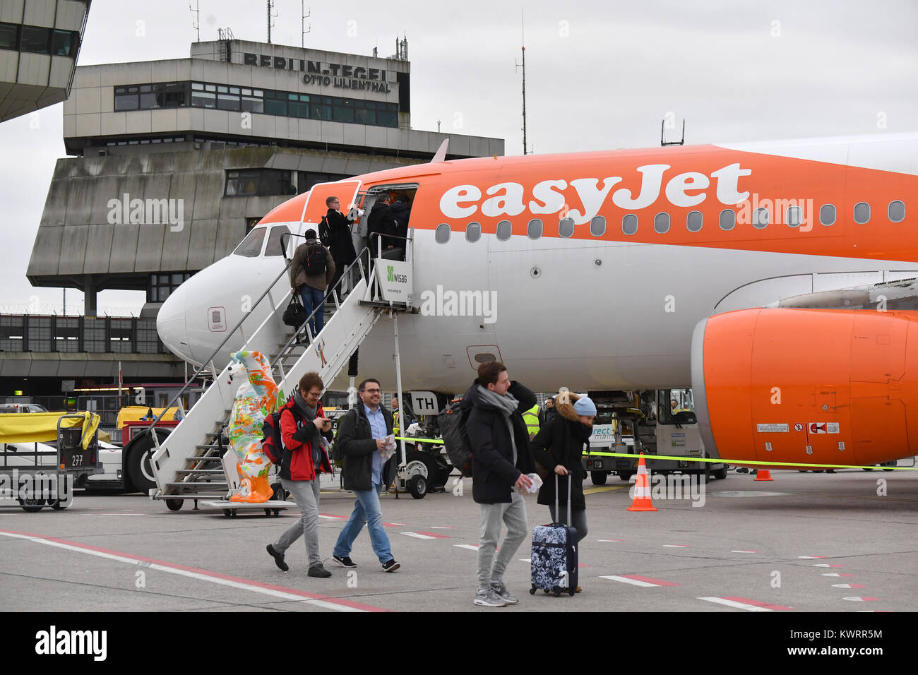 Passengers board an easyJet plane at Tegel Airport in Berlin, Germany ...
