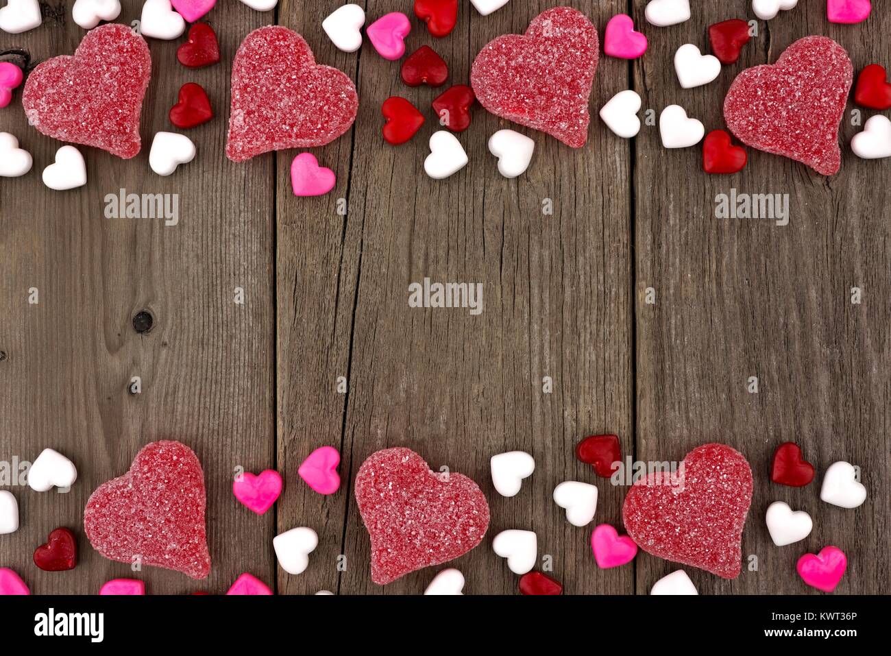 Valentines Day heart shaped candy double border on a rustic wood ...