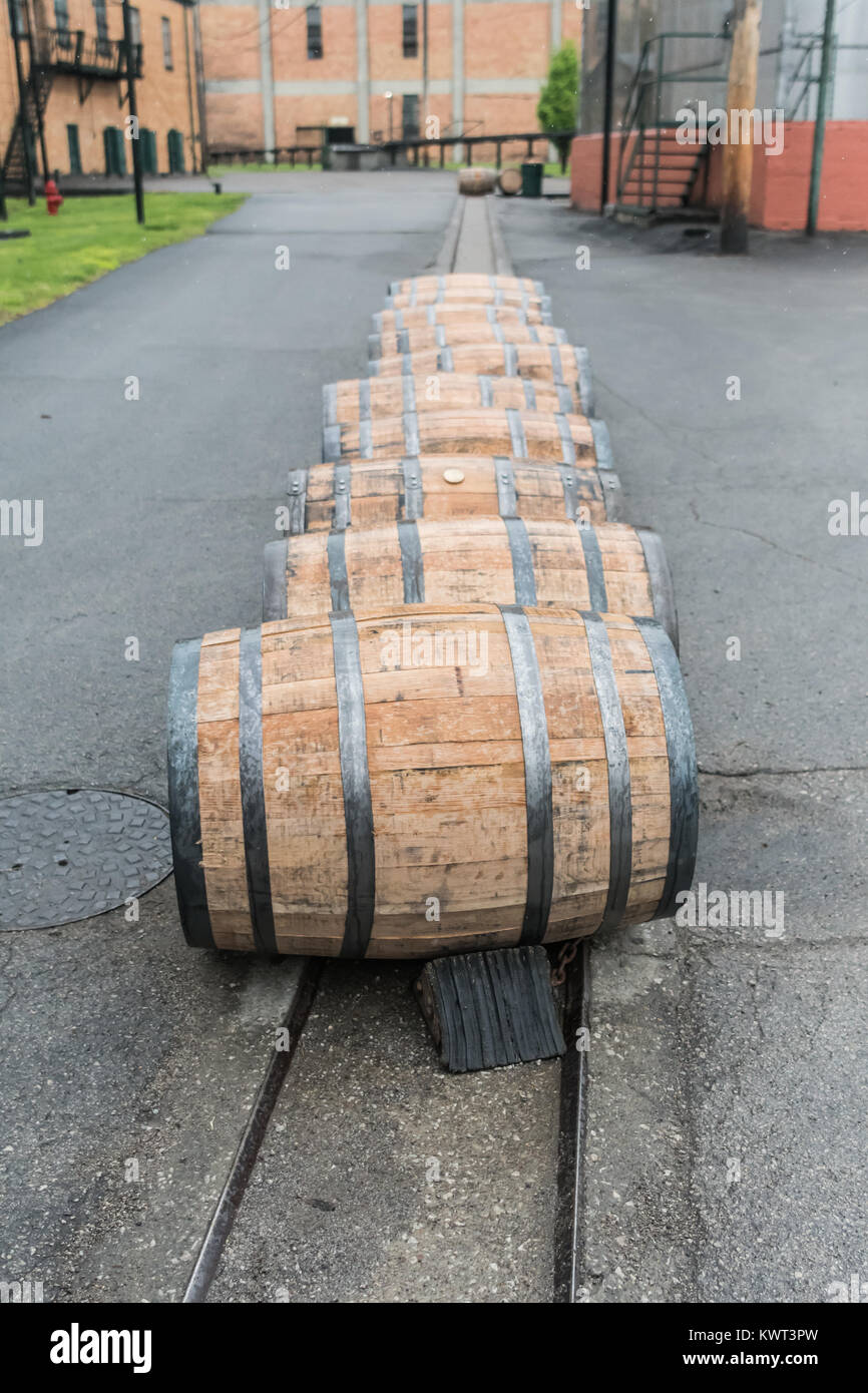 Line of Bourbon Barrels in the Rain Rolling Down Track Stock Photo - Alamy