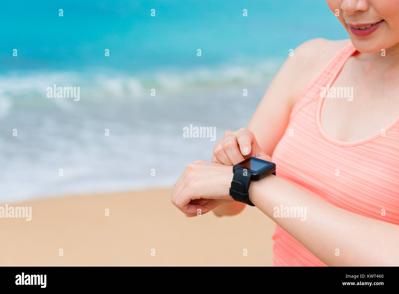 young professional female runner wearing smartwatch for workout fitness ...