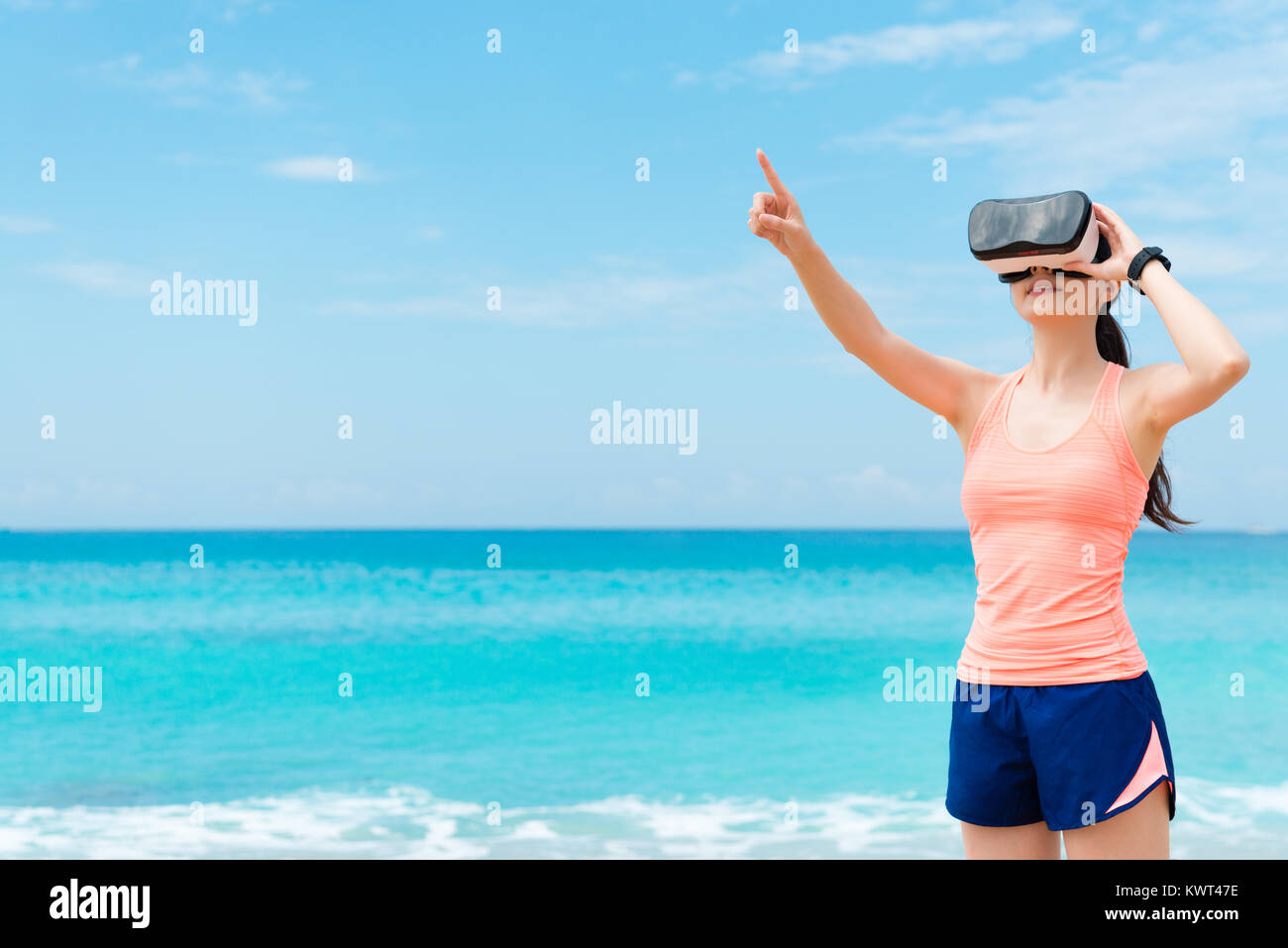 beautiful happy woman runner wearing VR technology glasses watching 3D ...