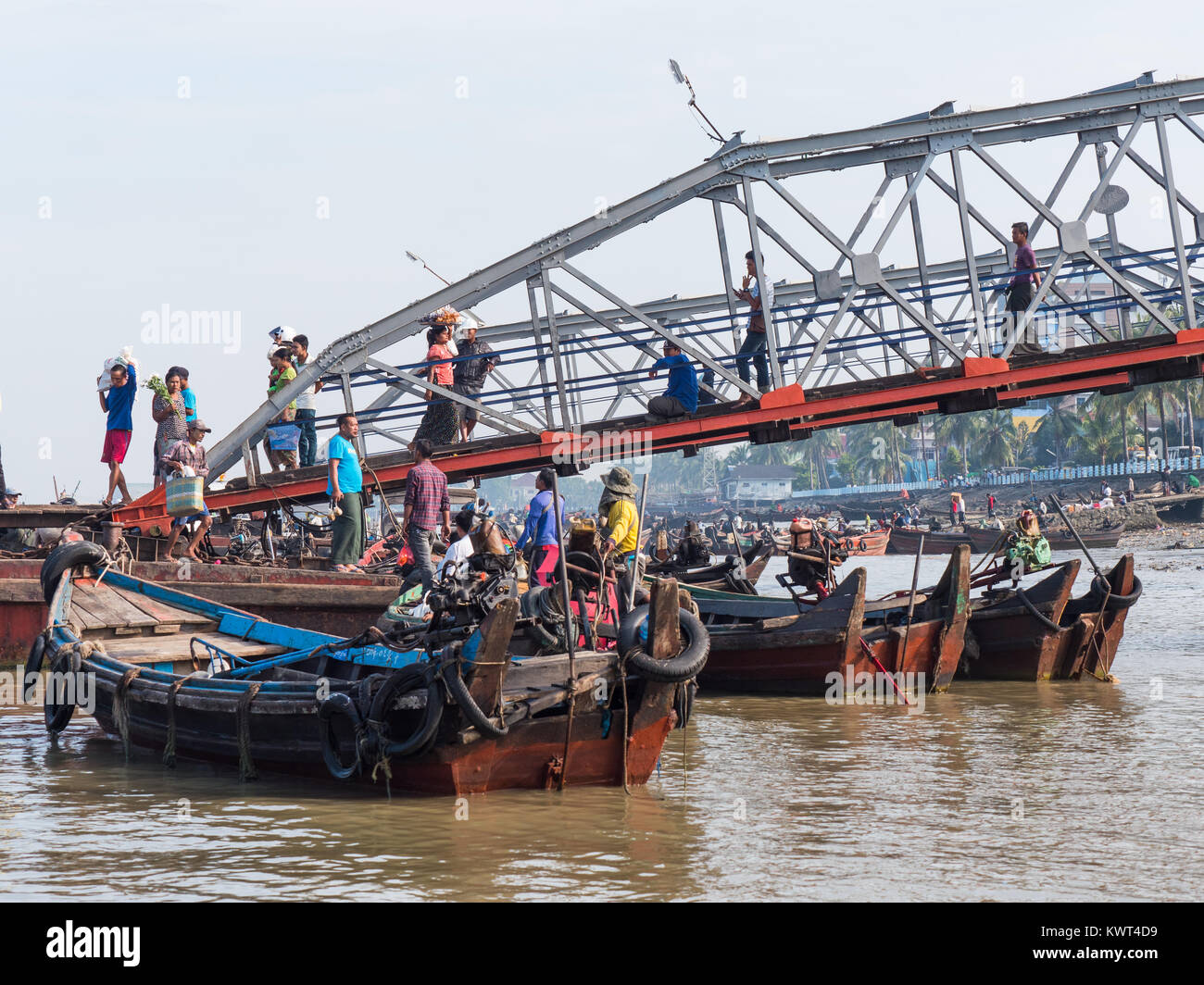 Bridge to a floating pier and traditional wooden boats at the harbour ...