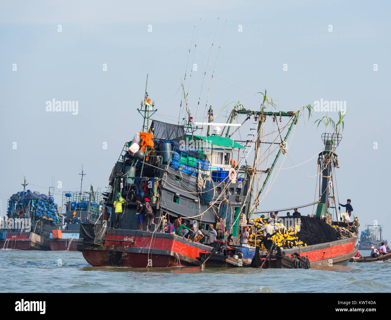 Fishing boat preparing for departure at the harbour of Myeik ...