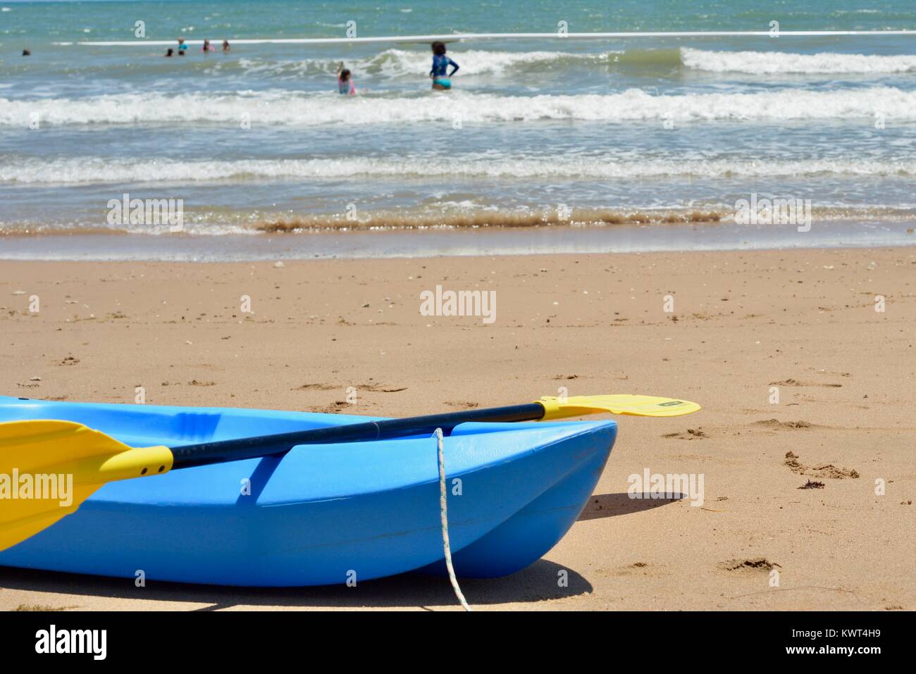 Blue kayak canoe on a beach with waves and people, Bagal Beach near ...