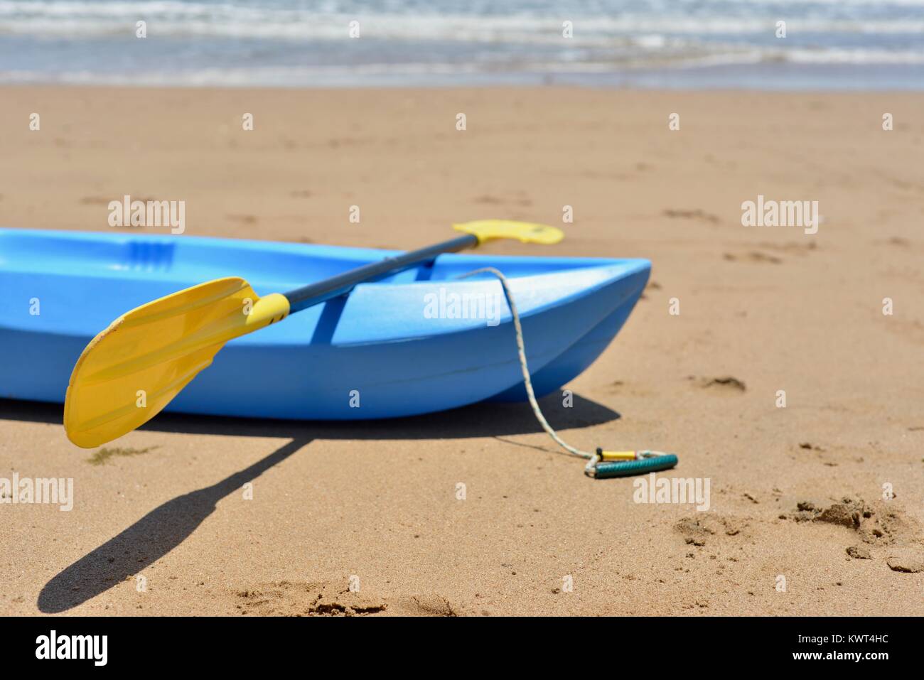 Blue kayak canoe on a beach with waves and people, Bagal Beach near ...