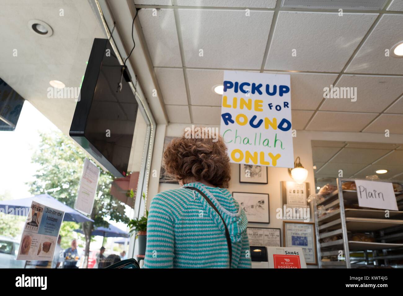 A woman in line to pick up a challah bread for the Jewish high holiday ...