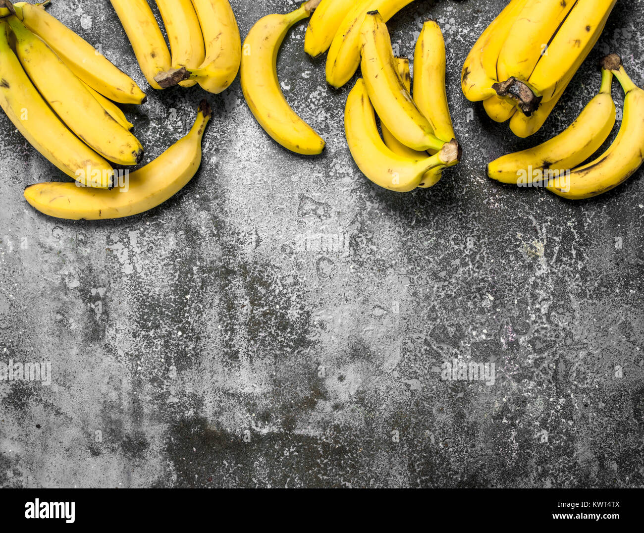 Fresh bunches of bananas. On a rustic background Stock Photo - Alamy