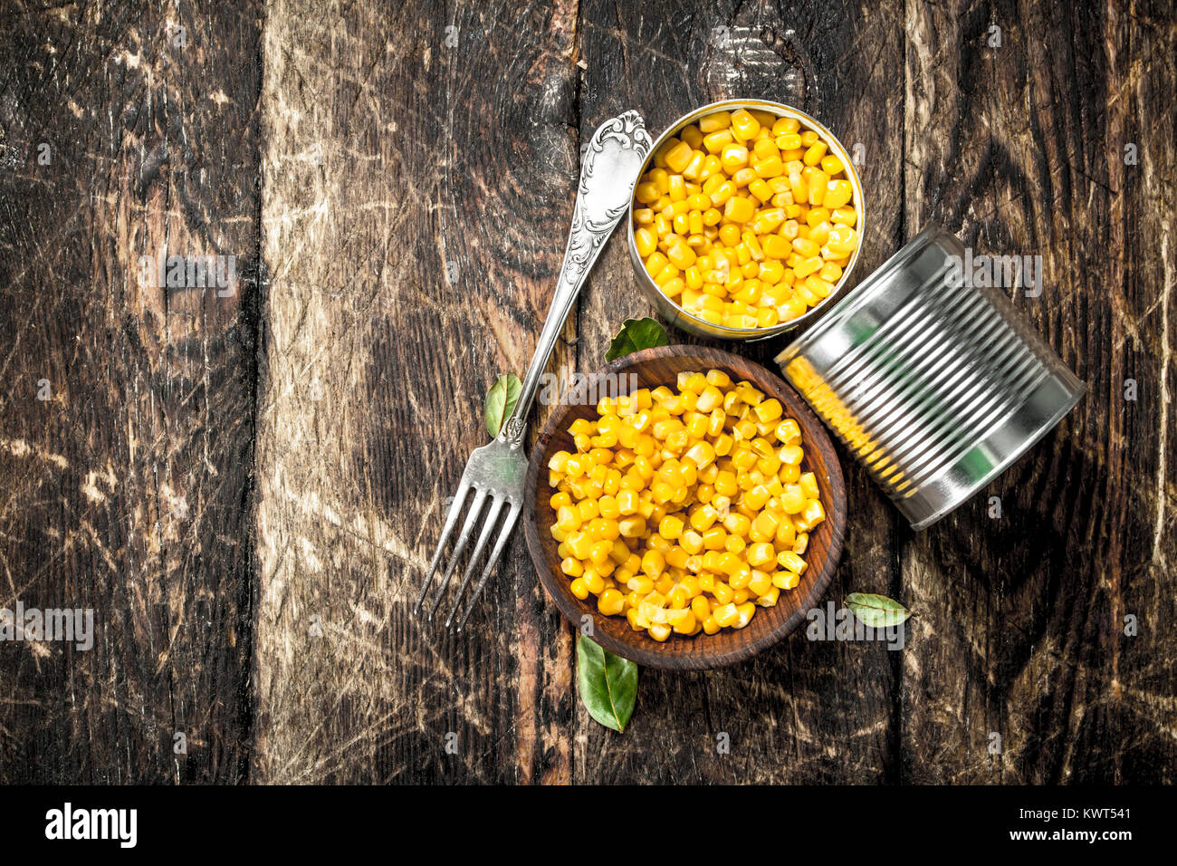 Canned corn in a tin can with fork. On a wooden background Stock Photo ...
