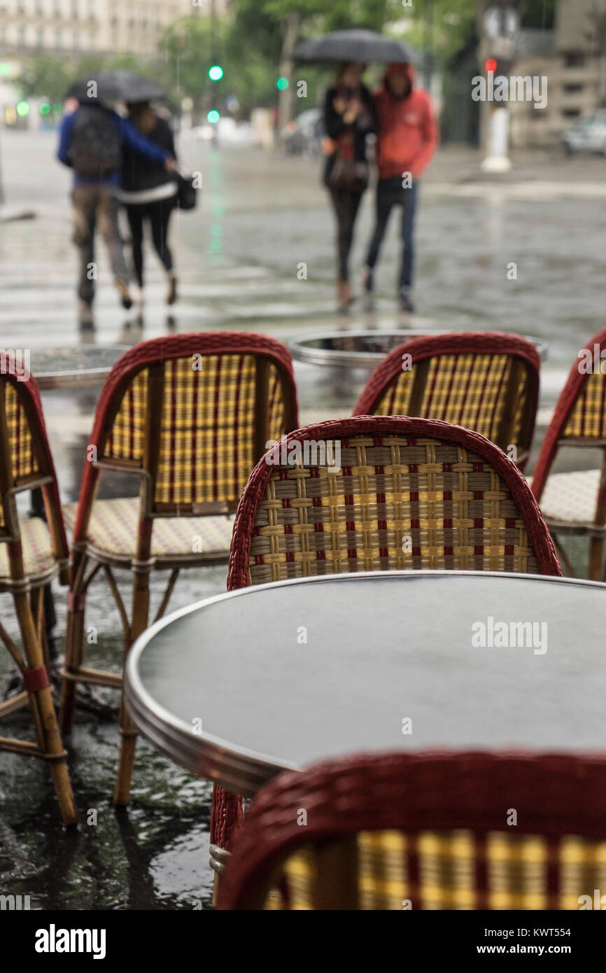 France, Paris, Couples crossing street in rain viewed from a cafe Stock ...