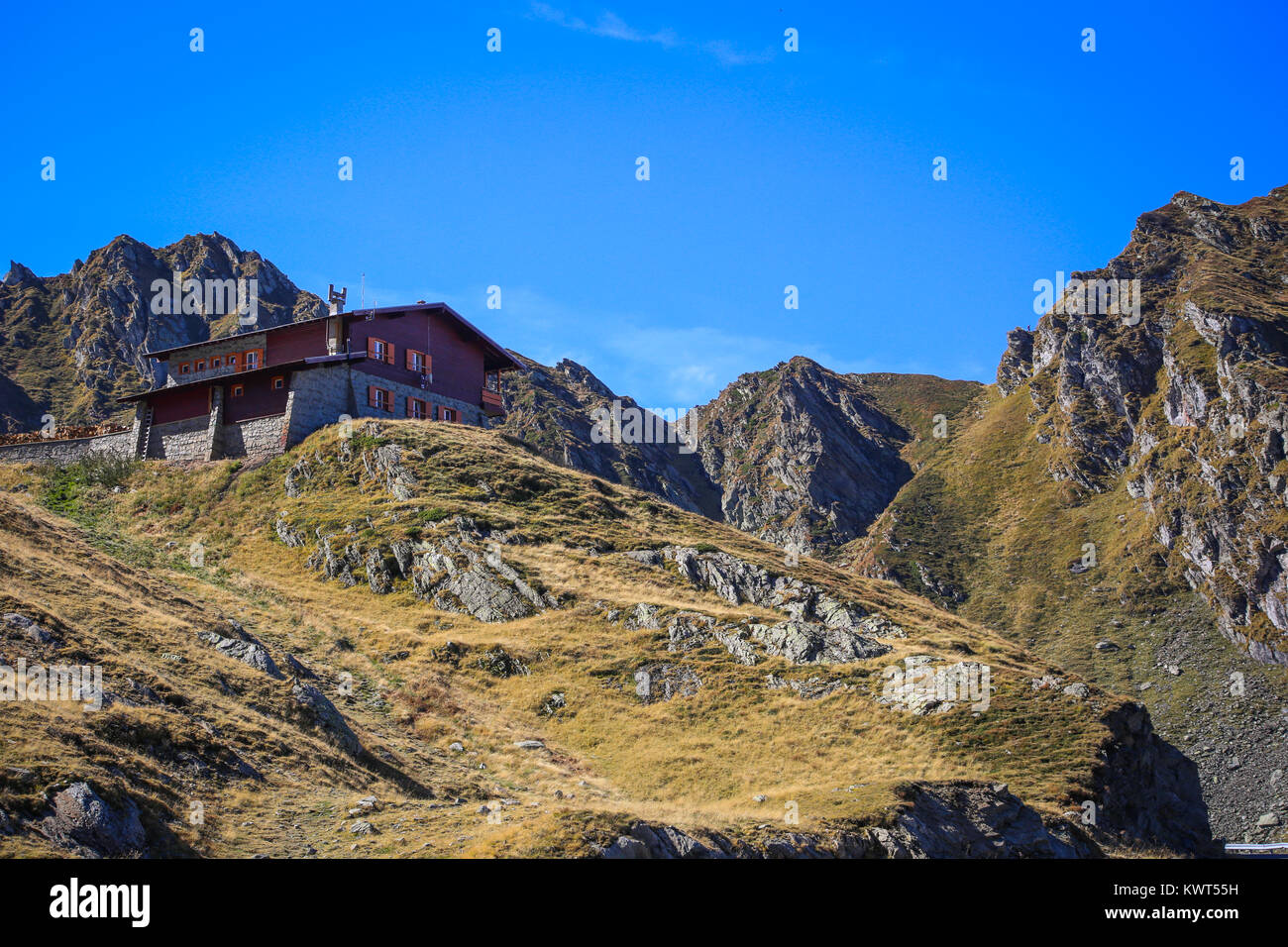 Autumn landscape with cabin and Fagaras mountains in the background at ...