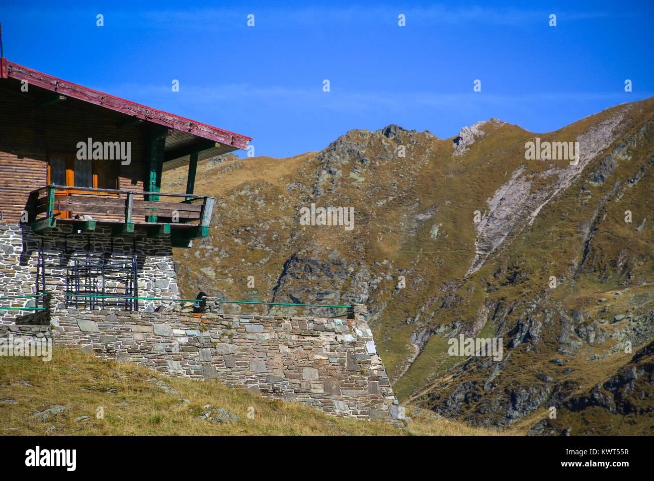 Autumn landscape with cabin and Fagaras mountains in the background at ...