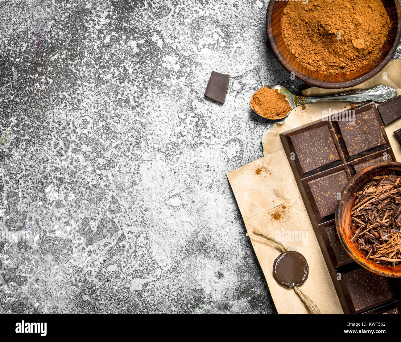 chocolate bar with cocoa powder. On a rustic background Stock Photo - Alamy